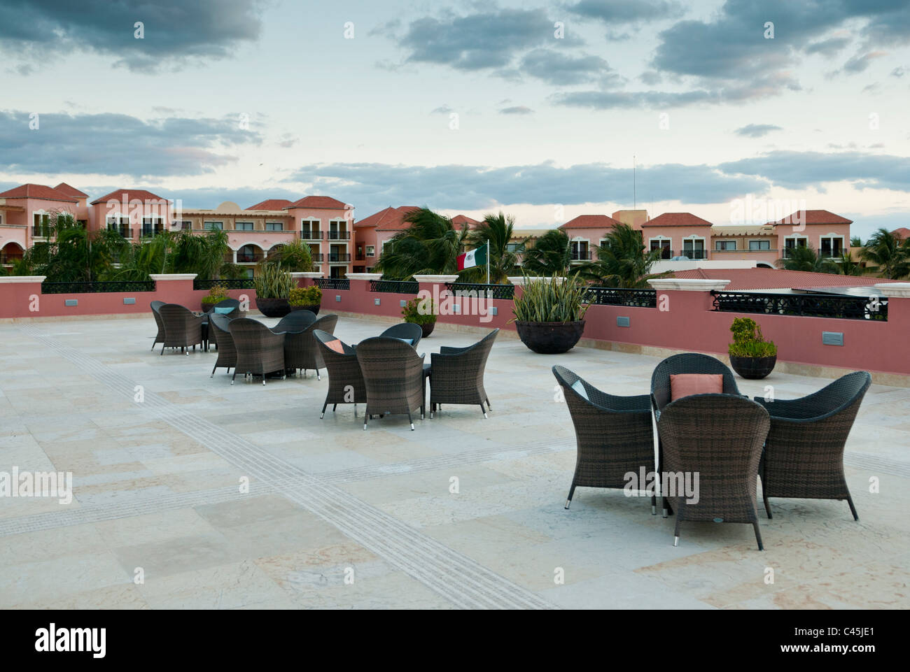 An upper deck patio with seating at a vacation resort on the Mayan ...