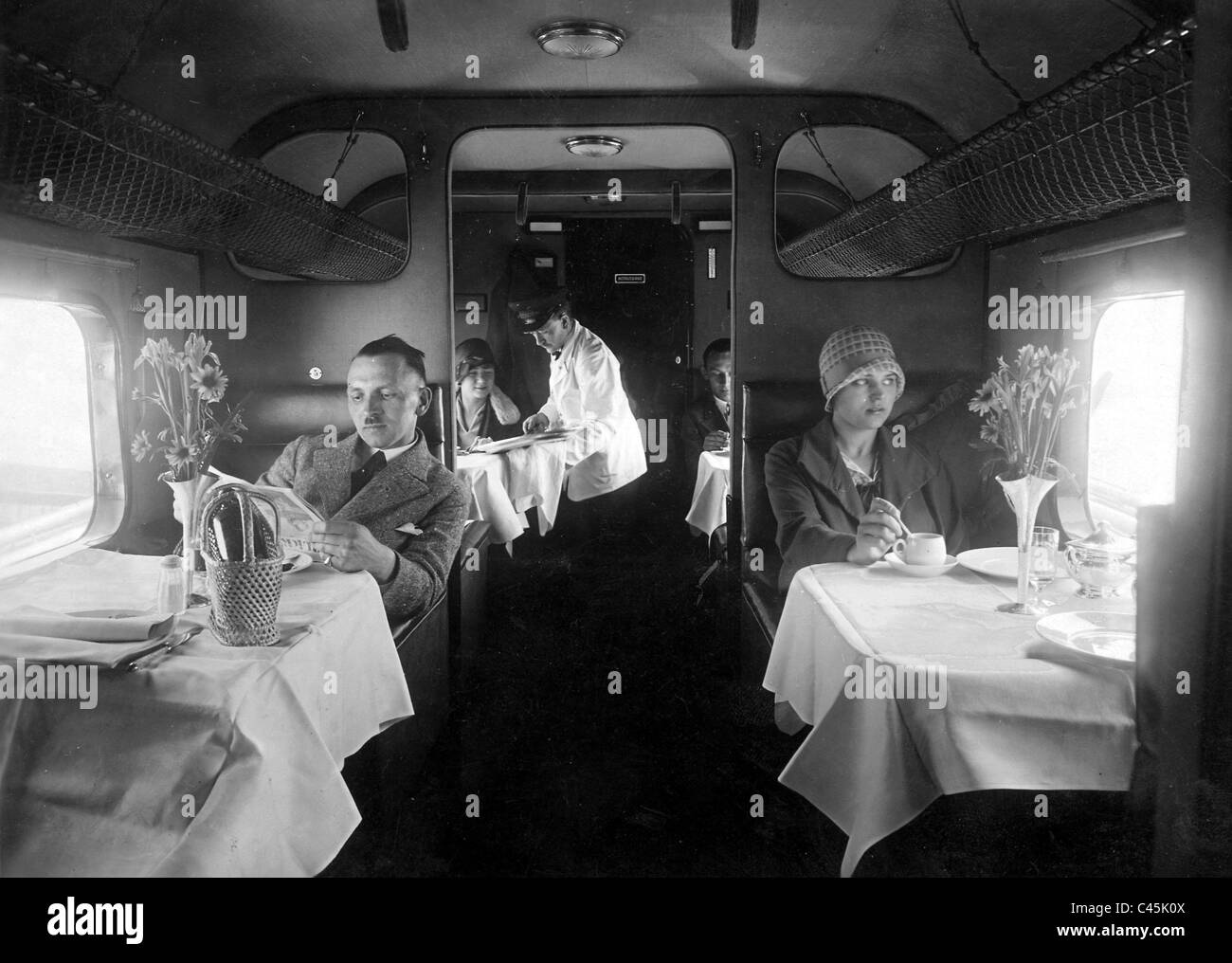 A steward serves flight guests on board a Junkers G-31, 1928 Stock ...