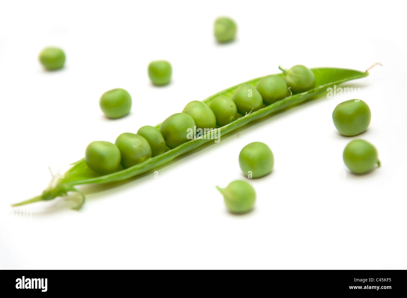 Green peas pods over a white background Stock Photo - Alamy