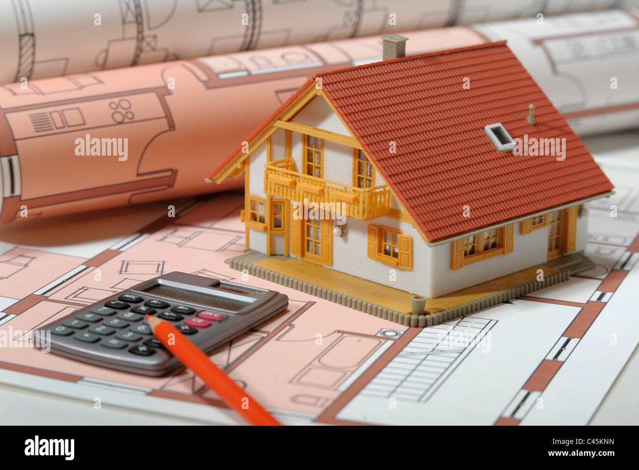 model house on architecture plan with financial calculator Stock Photo ...