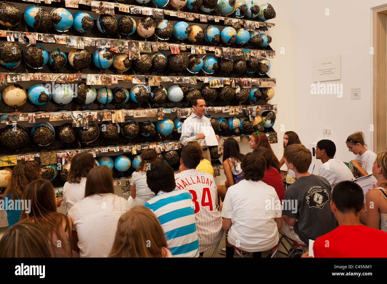 museum guide or teacher lecturing to high school students at ...