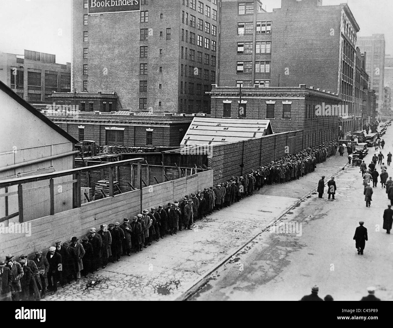 Queue of unemployed in front of a factory gate, 1932 Stock Photo - Alamy