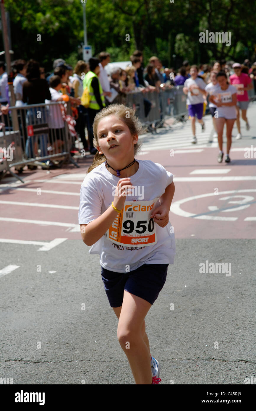 Girl running in road race, Barcelona, Spain Stock Photo - Alamy