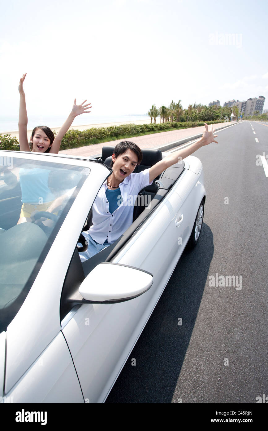 Driving convertible smiling couple beach hi-res stock photography and ...