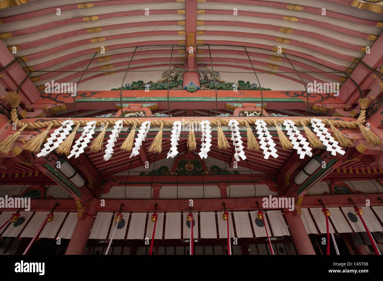 Detail of shrine at Fushimi-Inari Taisha shrine with robe, straw, bells ...