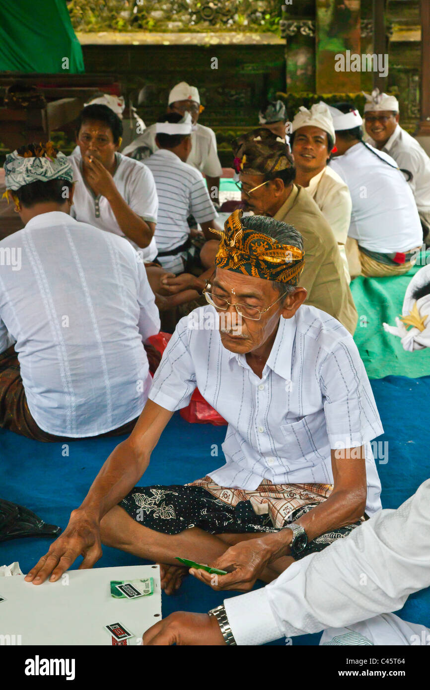 BALINESE MEN play cards at PURA TAMAN SARASWATI during the GALUNGAN ...