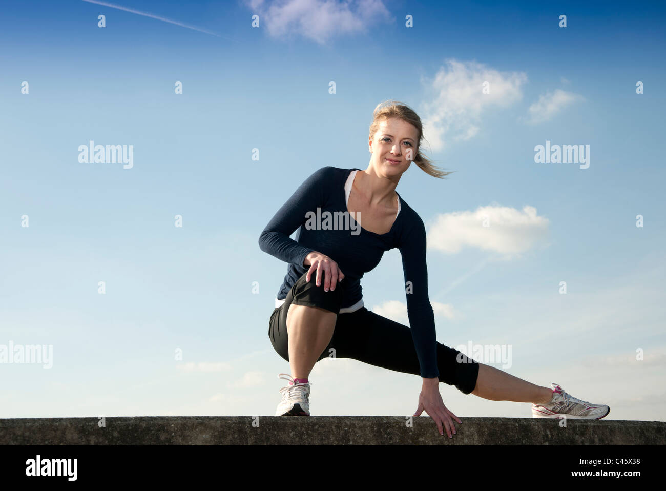woman stretching leg muscles pre and post workout Stock Photo - Alamy