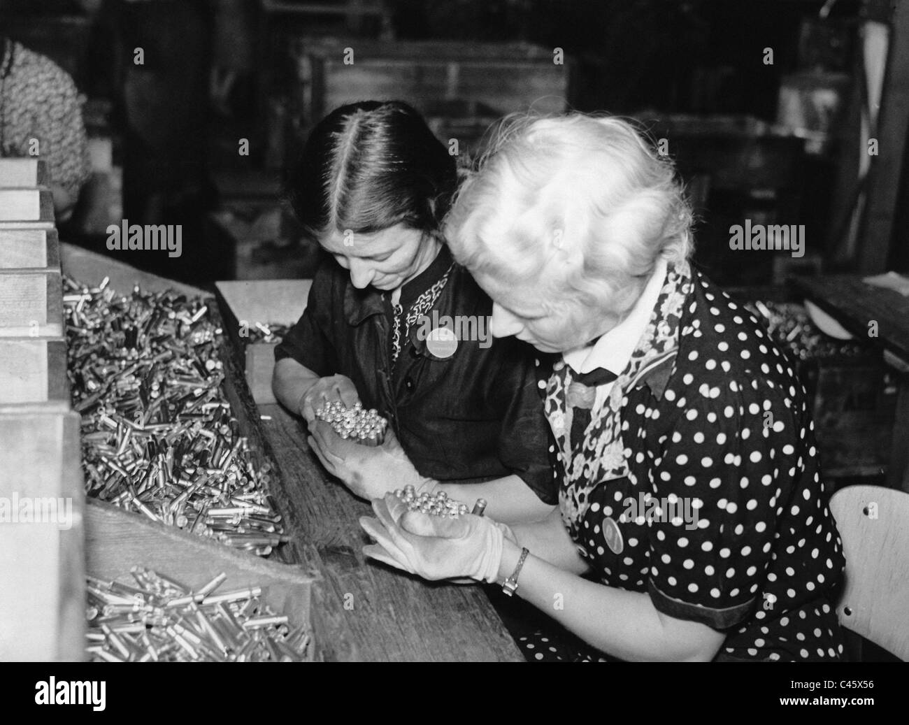 BDM leader and worker in a munitions factory, 1940 Stock Photo - Alamy