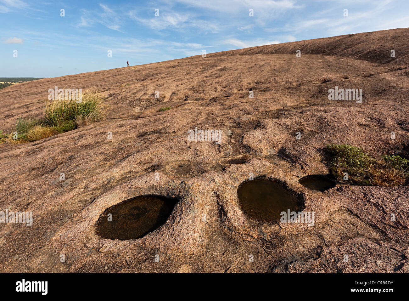 Vernal pools with walker on skyline Enchanted Rock State Natural Area ...