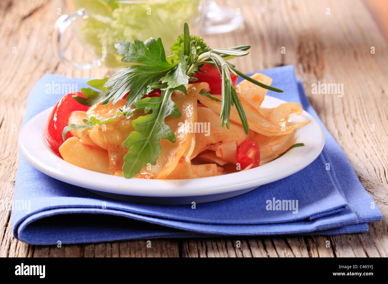 Sheet pasta with tomatoes and salad greens Stock Photo - Alamy
