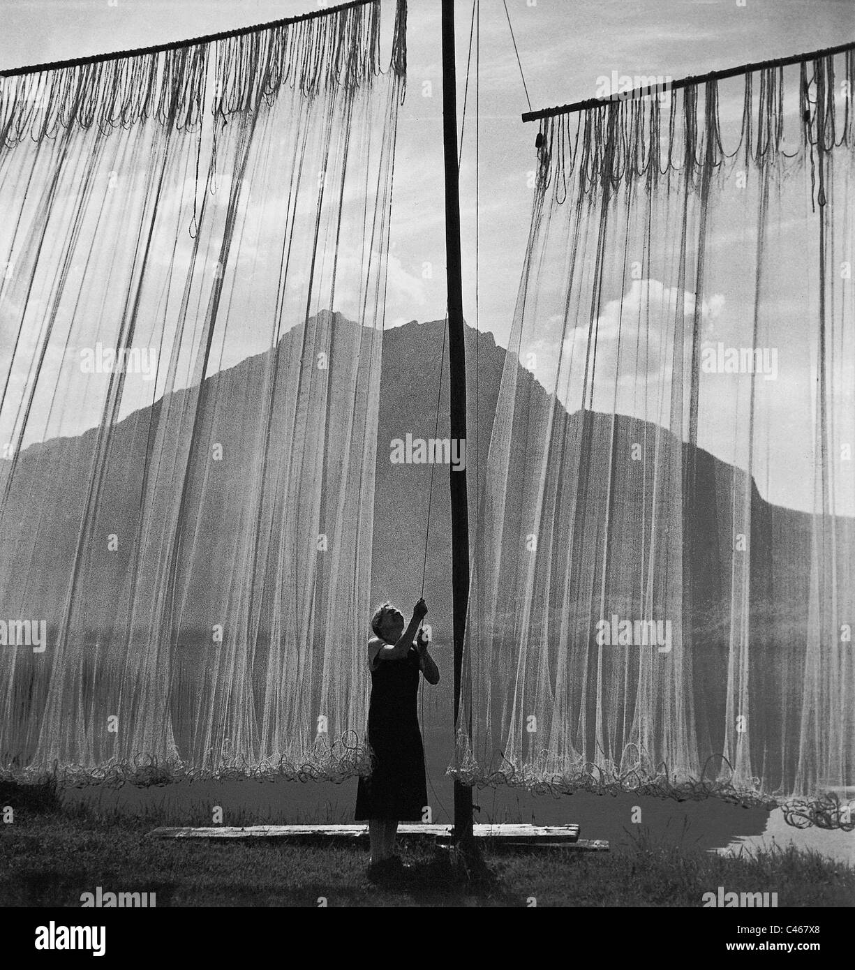 Woman while unclamping of fishing nets, 1938 Stock Photo - Alamy