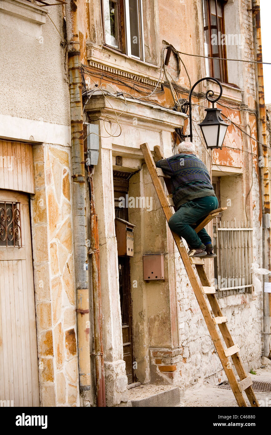 Handyman on a ladder outside a buliding in Plovdiv Bulgaria Stock Photo ...