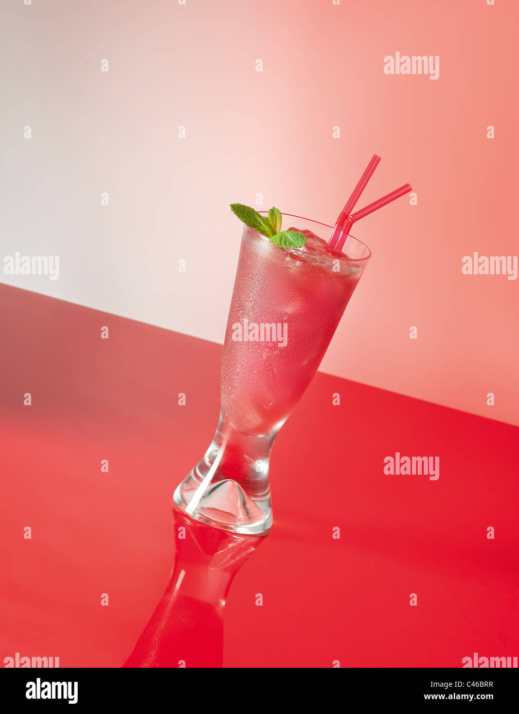 A tall cocktail glass with straws Stock Photo - Alamy