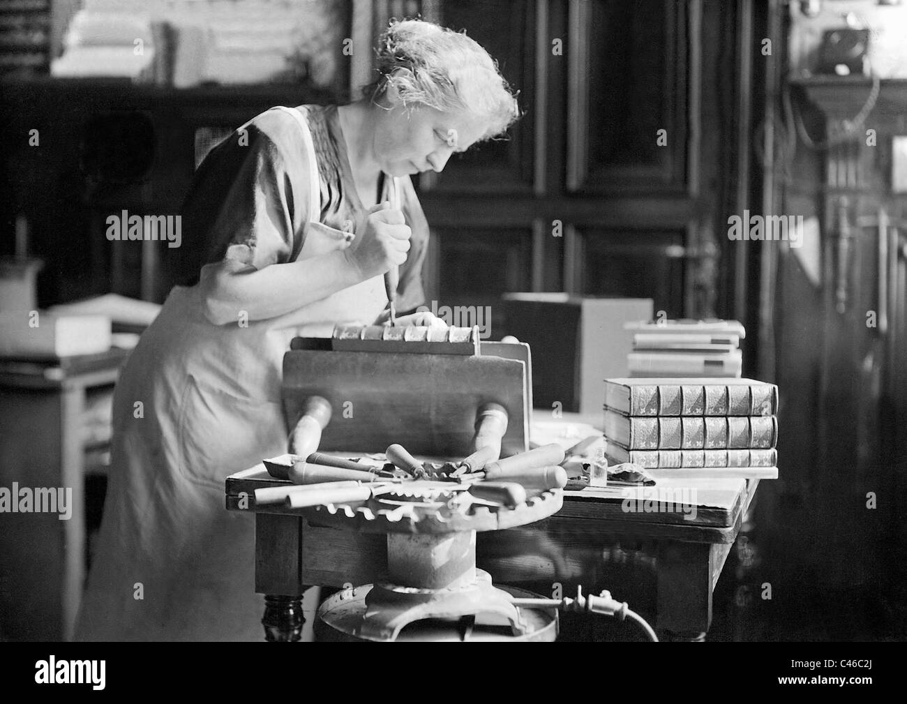 Bookbinder gilding the spine, 1938 Stock Photo - Alamy