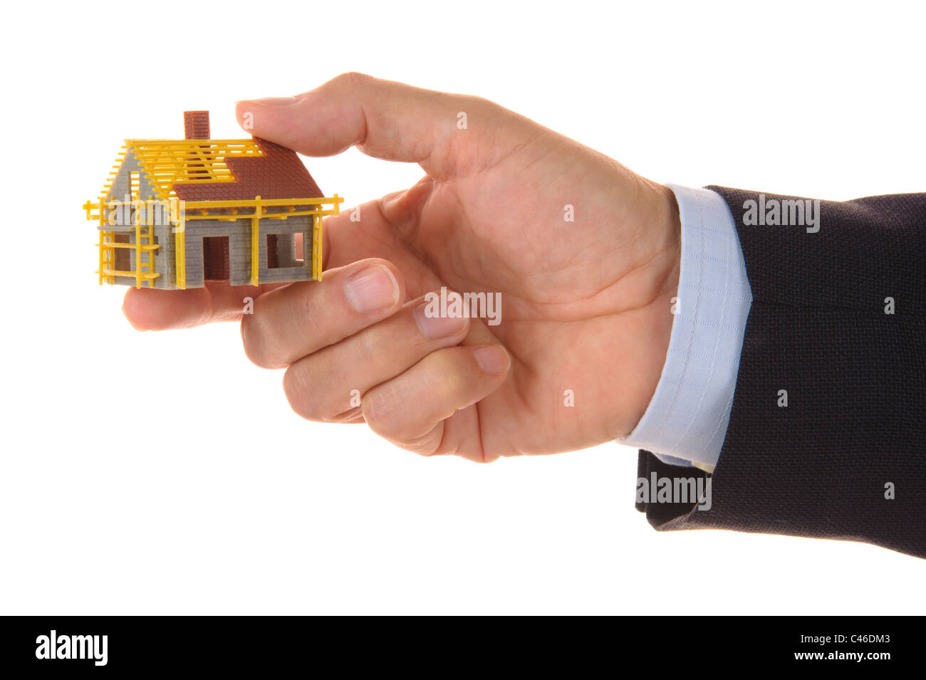 model house under construction in business hand isolated over white ...