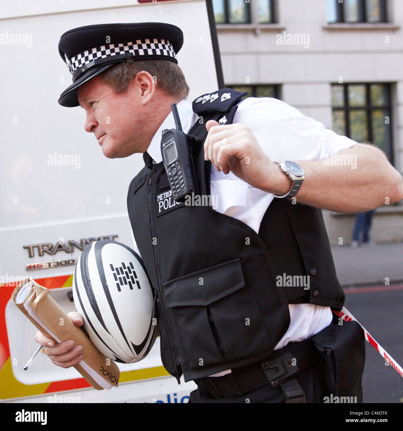 Policeman with rugby ball taken from an activist during an EDF Energy ...