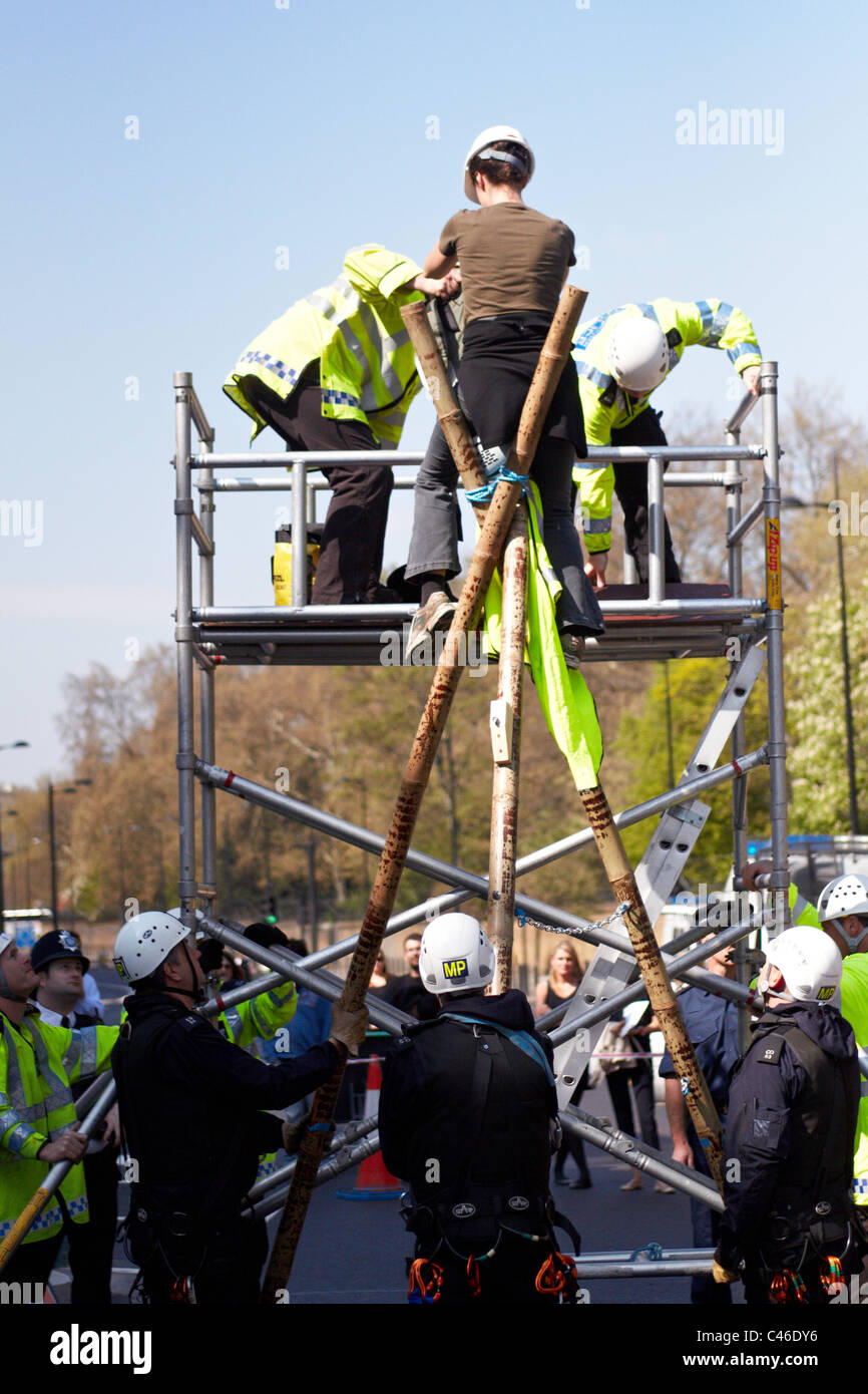 Protesters sit on top of tripods outside the London office of EDF ...