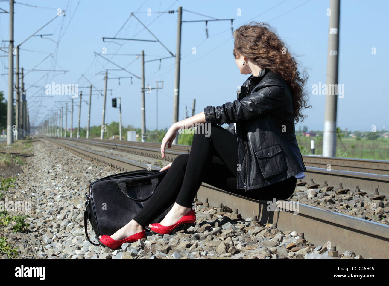 Beautiful girl sitting on railroad hi-res stock photography and images ...