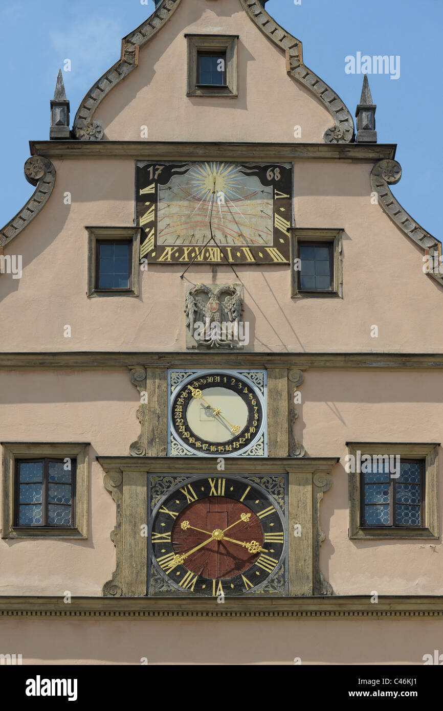 three different kind of clocks at the facade of town hall of medieval ...