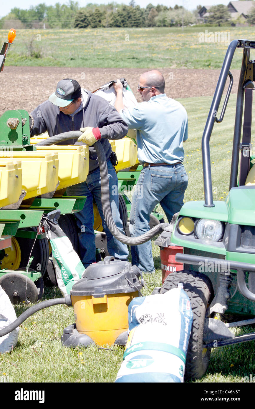 Workers prepare for sowing a seed demonstration plot. This involves ...