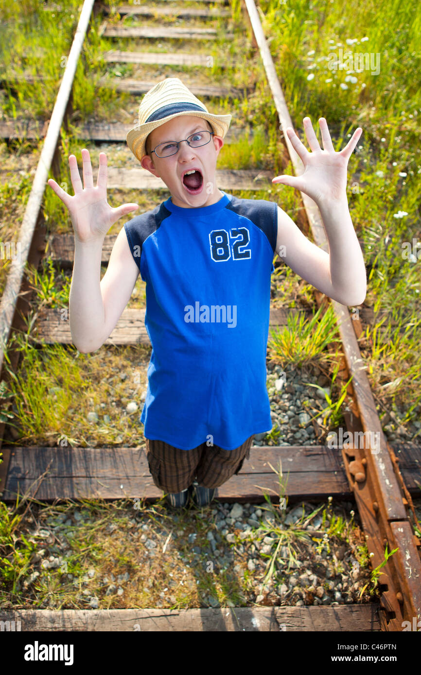 A frightened boy on train tracks Stock Photo - Alamy