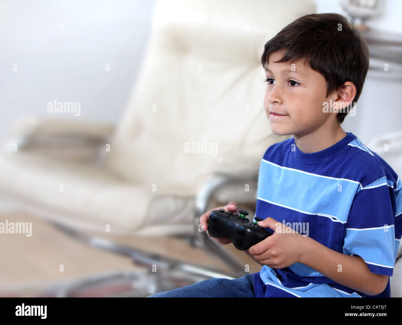 Young hispanic or Latino boy playing with a video game - with copy ...