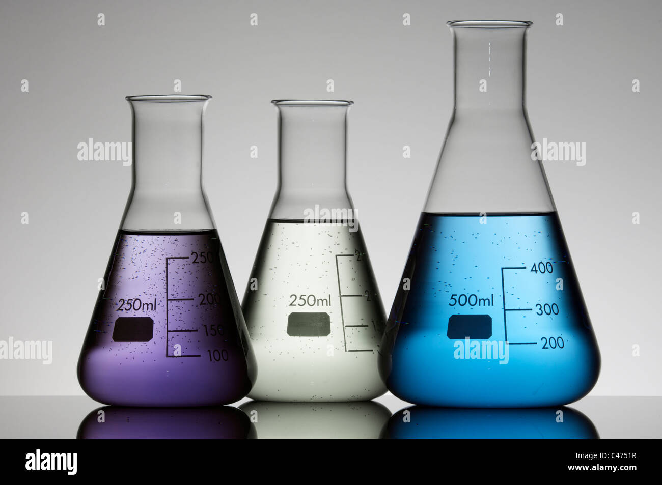 group of three conical flasks containing liquid shiny Stock Photo - Alamy