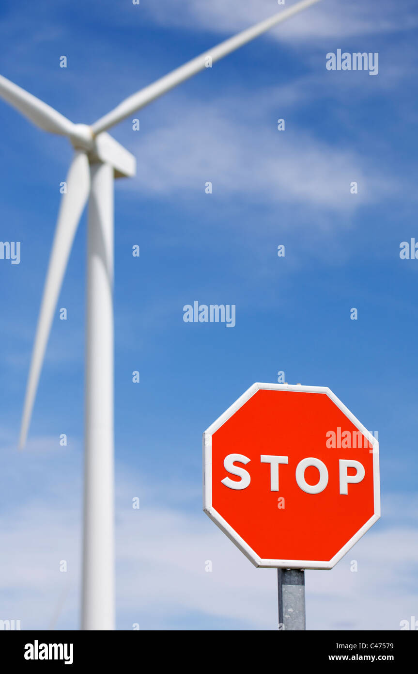 stop sign and modern windmill in the background Stock Photo - Alamy