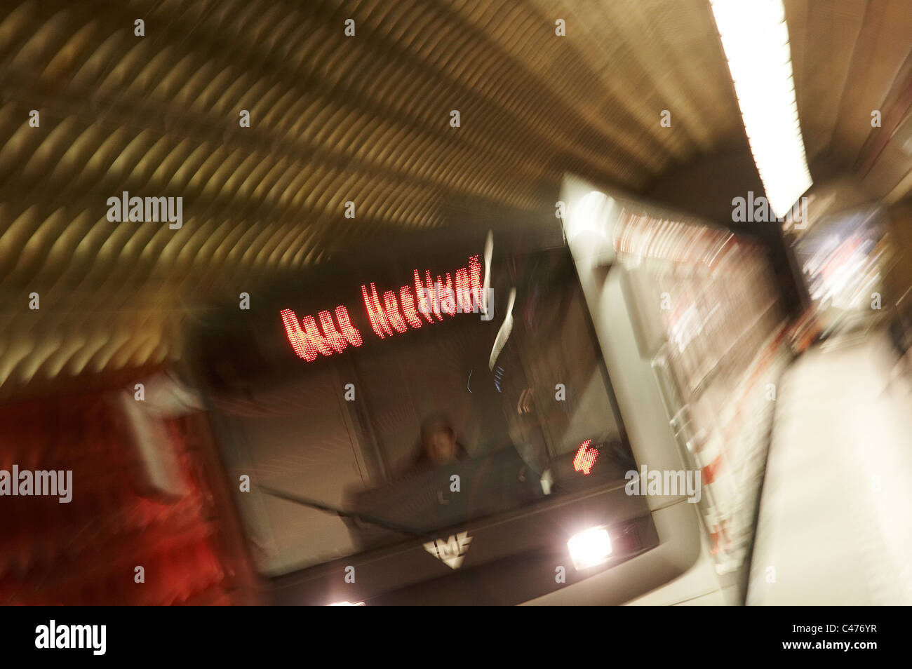 A photograph of the Prague metro system. A train arriving at the ...