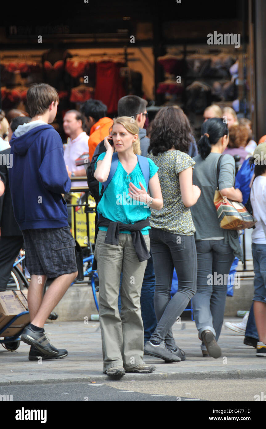 walking talking on mobile phone busy Oxford street London Stock Photo ...