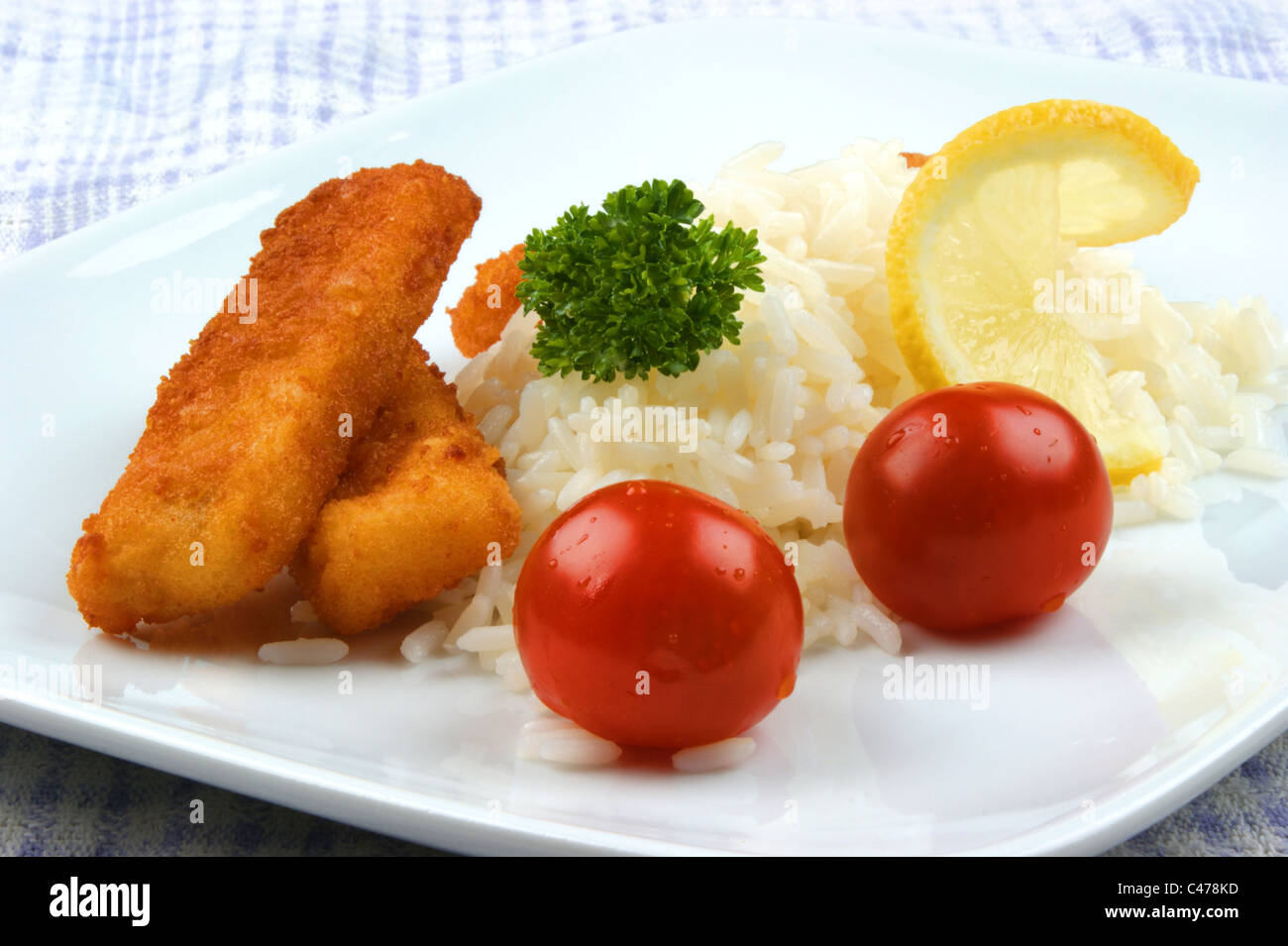 Fish fingers with rice on a plate Stock Photo - Alamy
