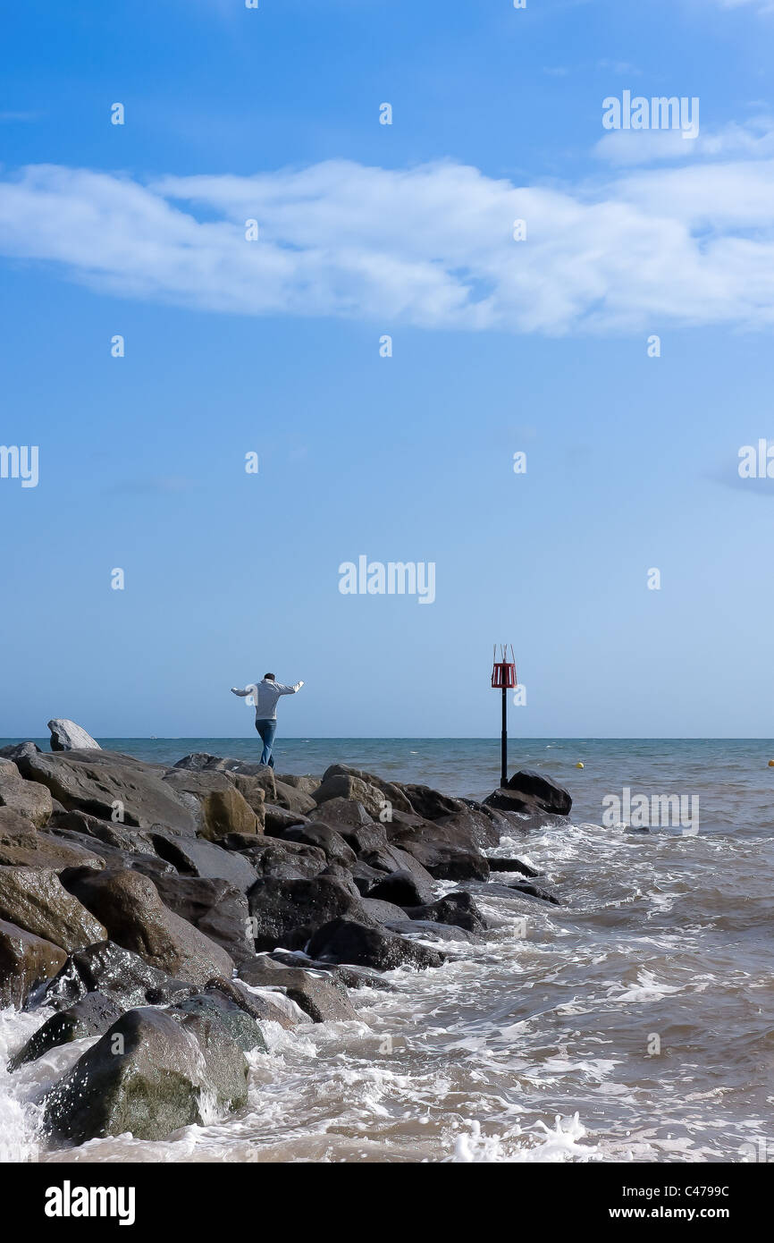 Man hopping over rocks at the beach, Sidmouth Stock Photo - Alamy