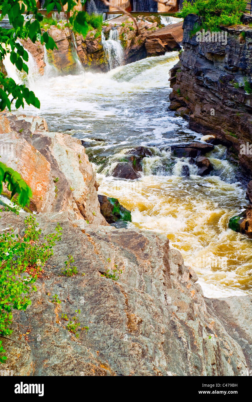 A violent, gushing rapids cut through a geological formation known as a ...