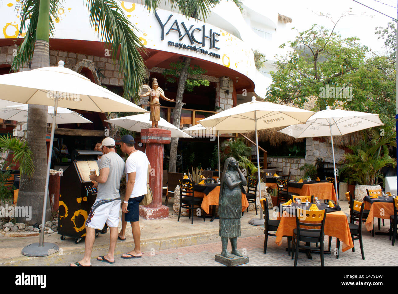 Two gay male tourists looking at the menu, Yaxche Mayan restaurant in ...