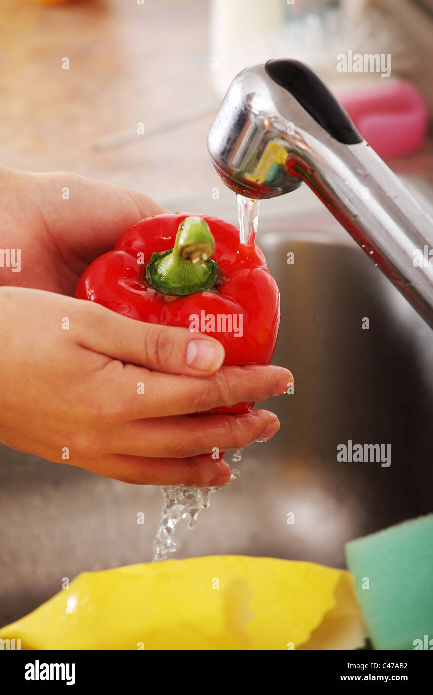 Woman hands washing red paprika Stock Photo - Alamy