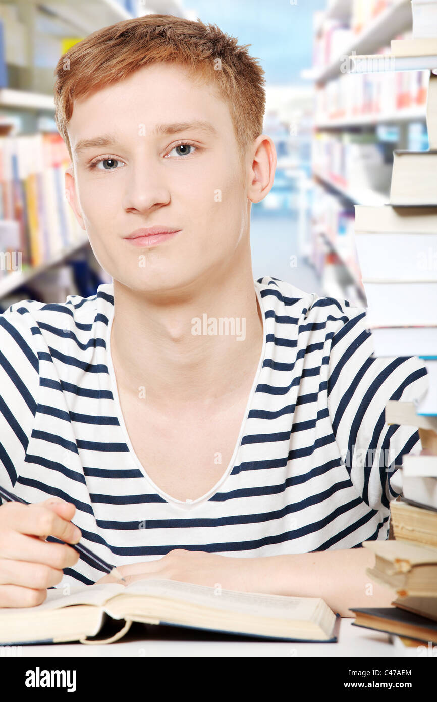 Teen boy learning at the desk Stock Photo - Alamy
