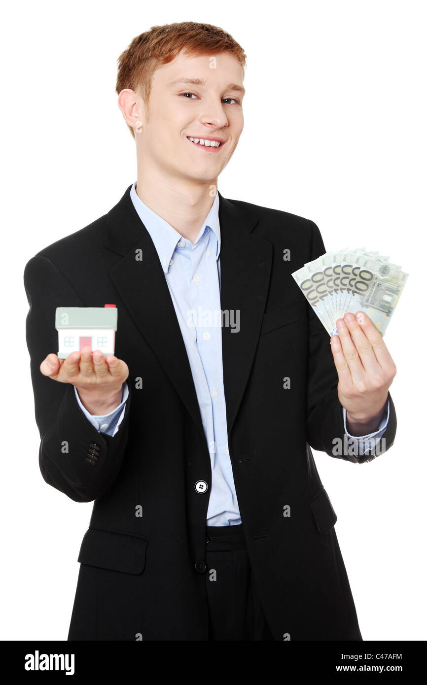 Businessman with money and house's model. Isolated on white background ...