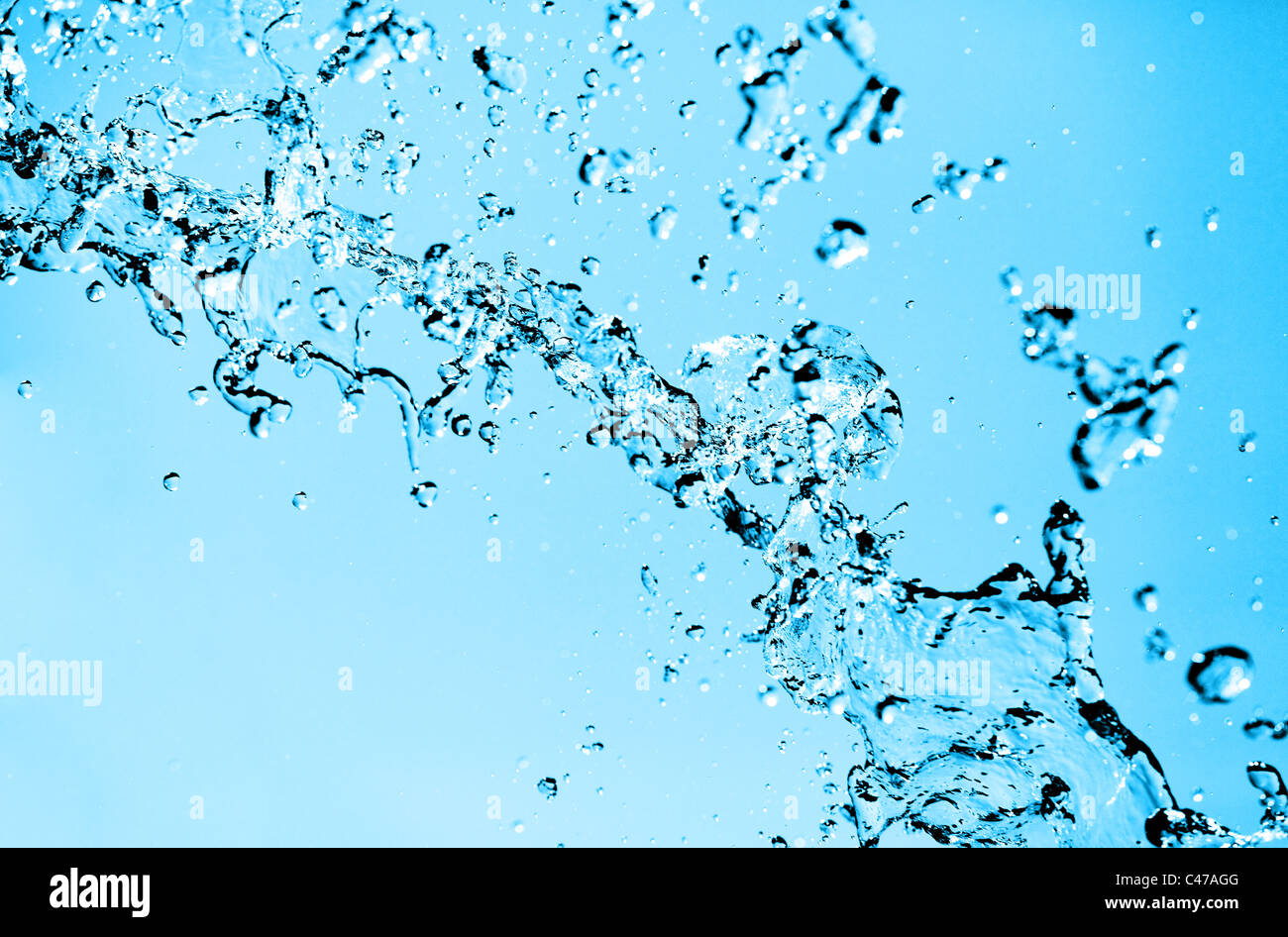 Water splash. Over blue background Stock Photo - Alamy