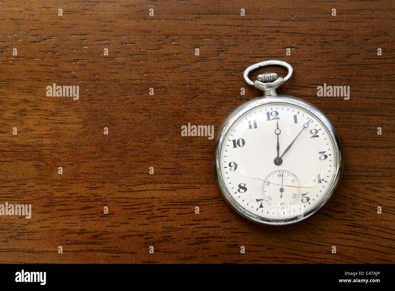 Pocket watch on wooden table Stock Photo - Alamy
