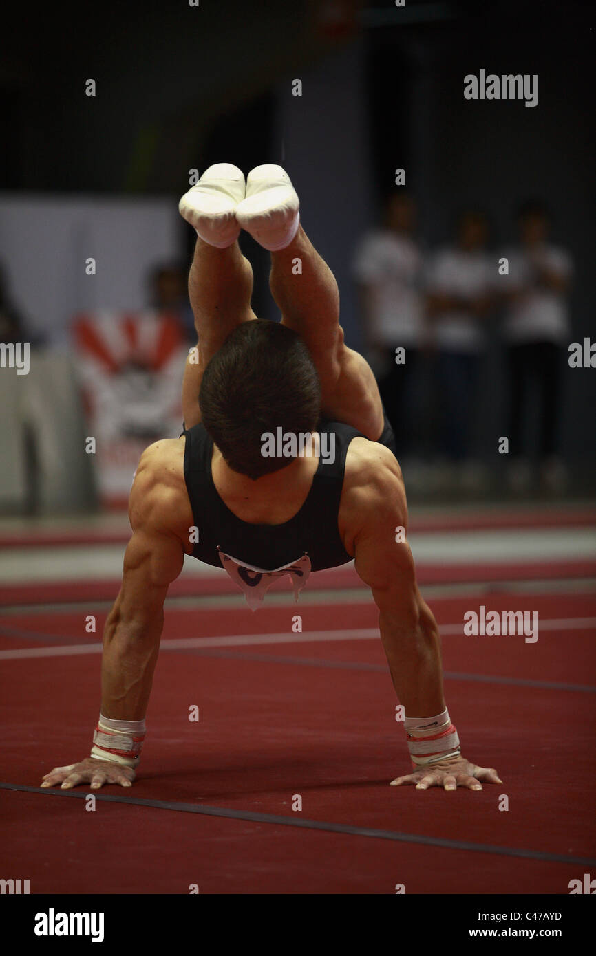gymnastics competition: a gymnast showing strength and flexibility in a ...
