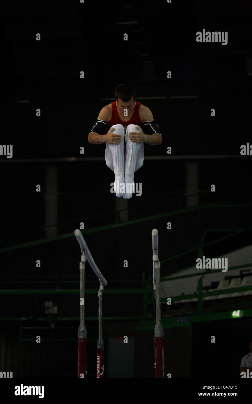 Gymnastics competition: a gymnast performing his parallel bars routine ...