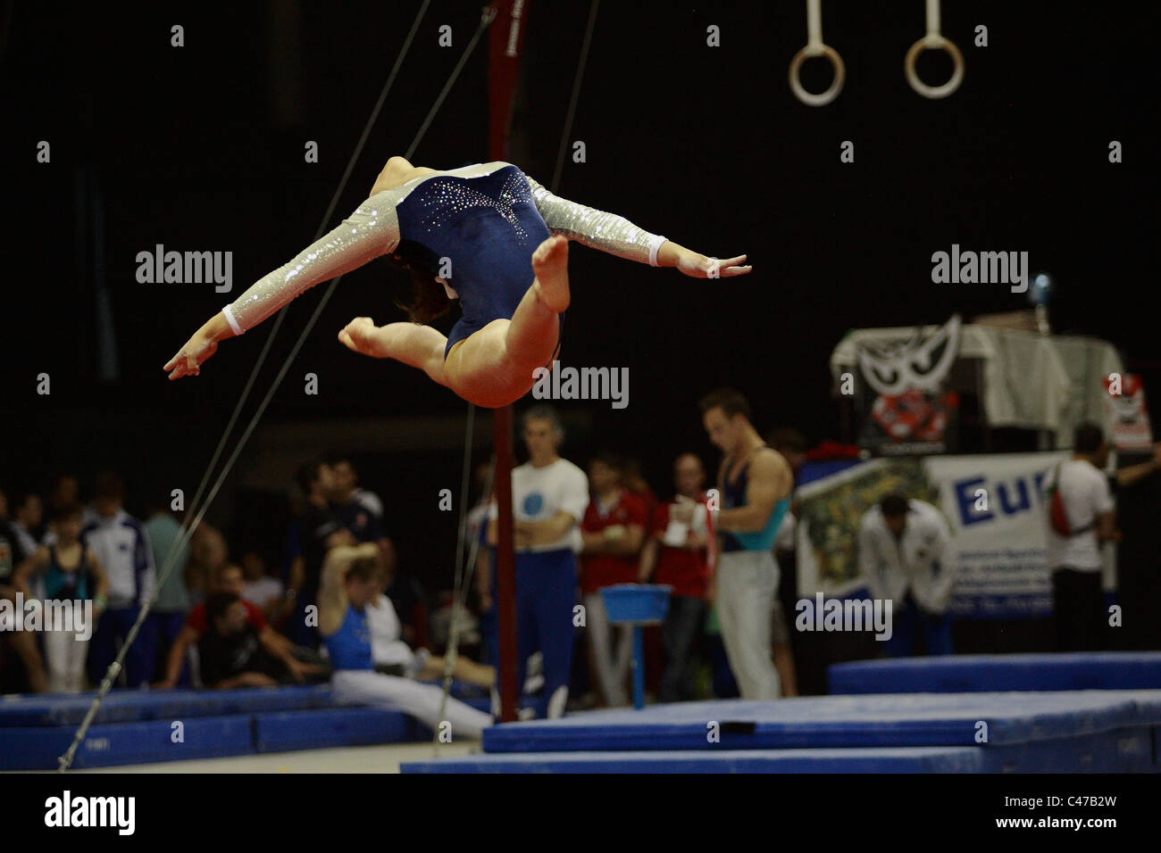Gymnastics competition: a gymnast performing a perfect artistic jump ...