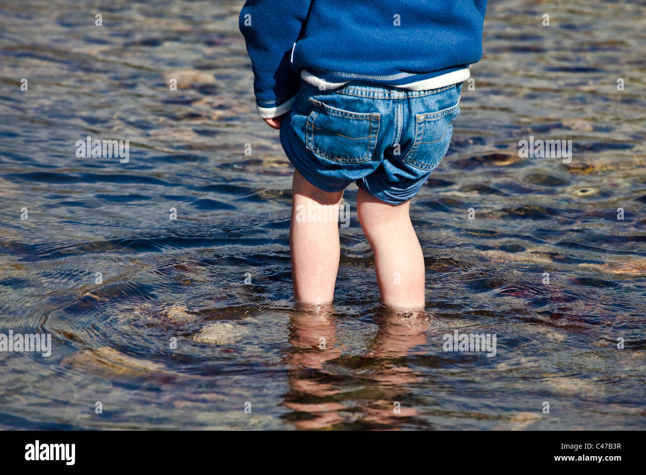 Child wading in the water Stock Photo - Alamy