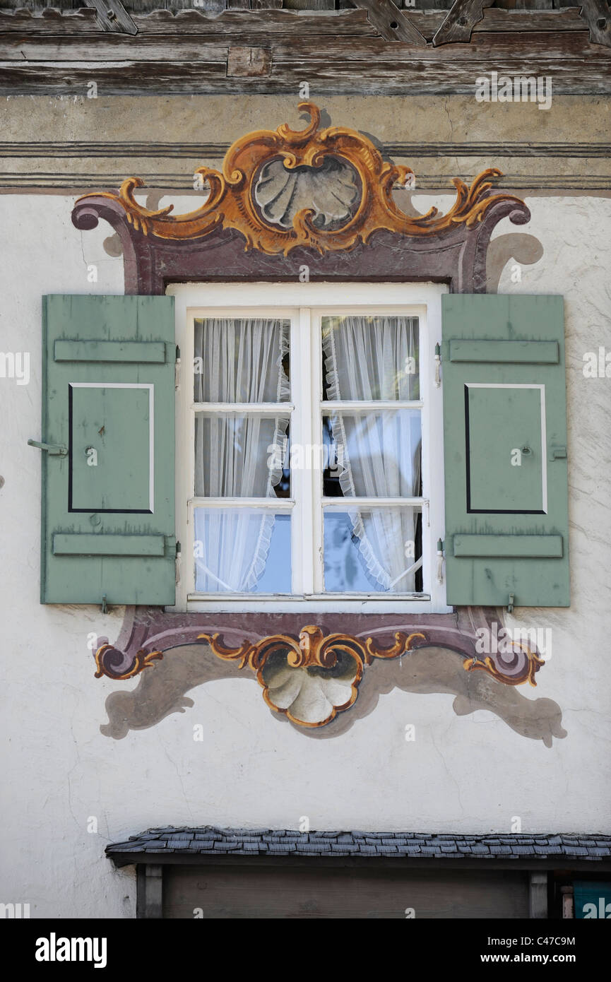 house facade and window decorated with traditional painting in Bavaria ...