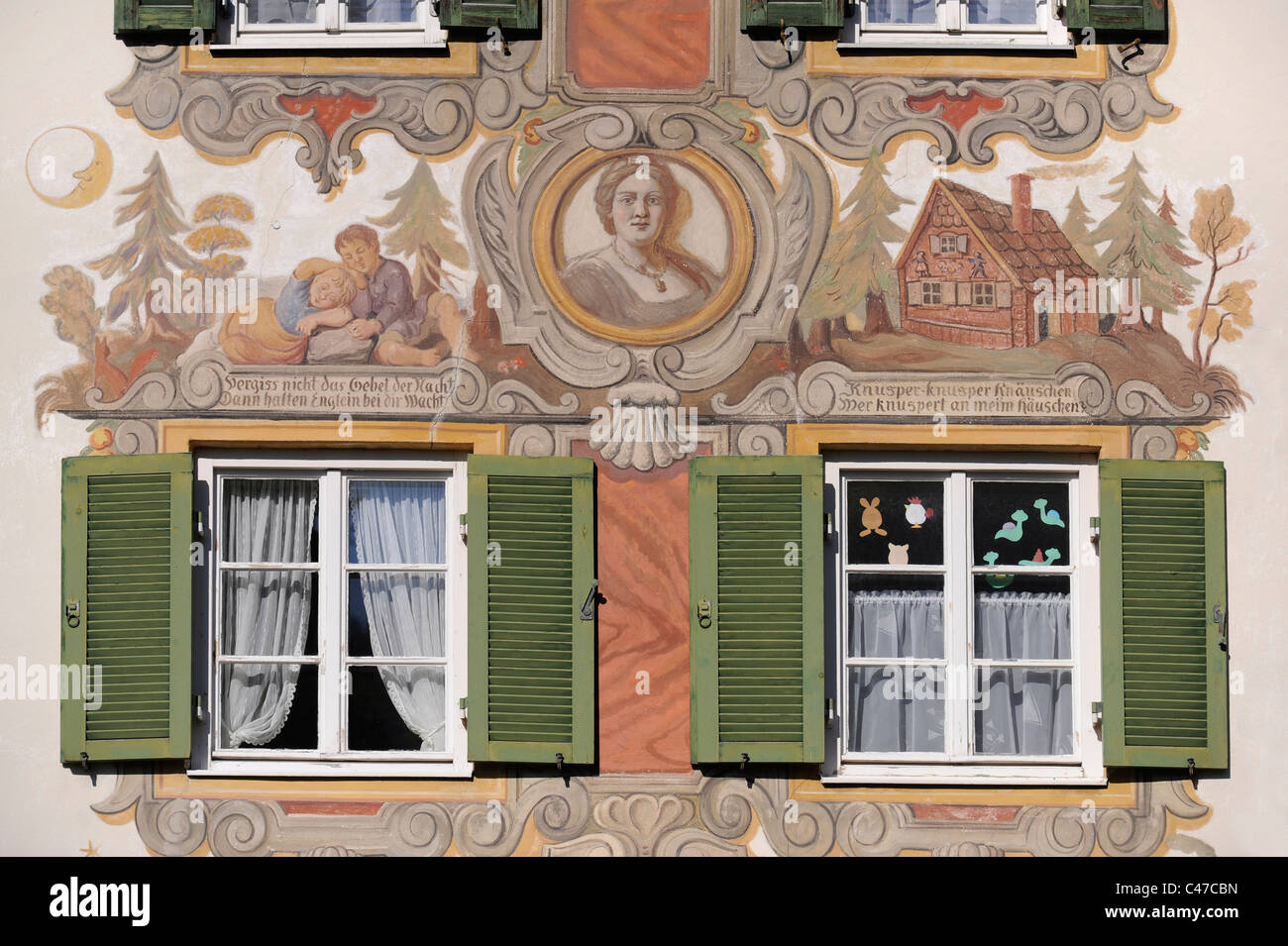 house facade and window decorated with traditional painting in Bavaria ...