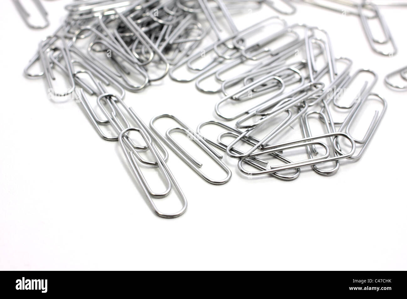 many paper clips isolated on white background Stock Photo - Alamy