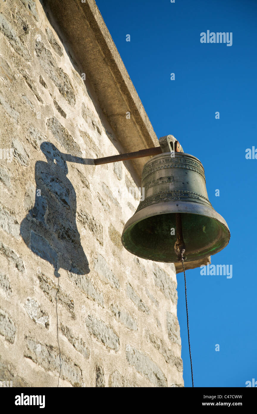 old green bell on a stone wall Stock Photo - Alamy
