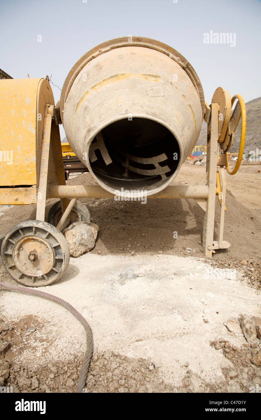 front view of a yellow working cement mixer Stock Photo - Alamy