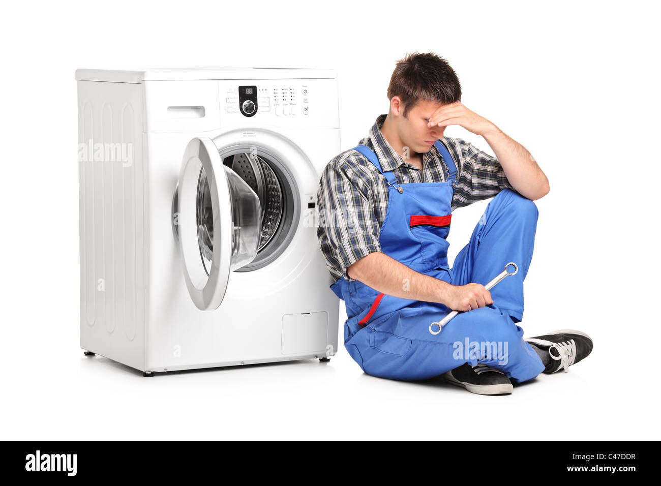 Desperate repairman posing next washing hi-res stock photography and ...