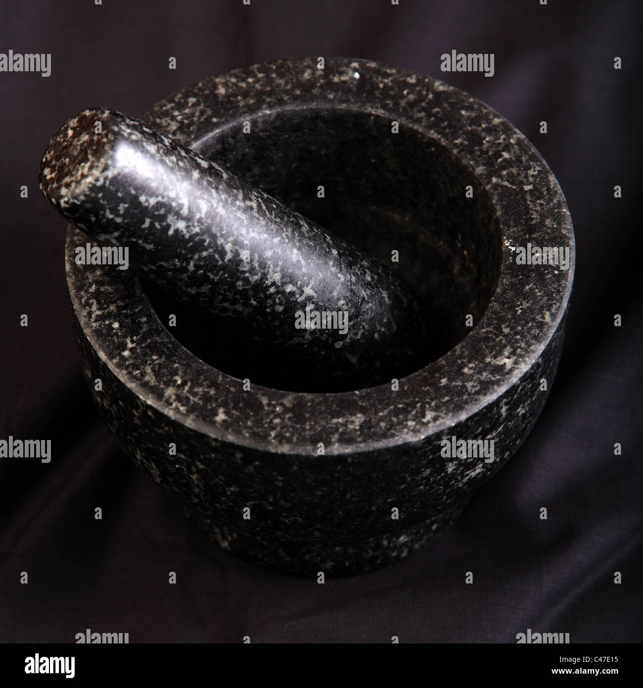 granite pestle and mortar on black background Stock Photo - Alamy